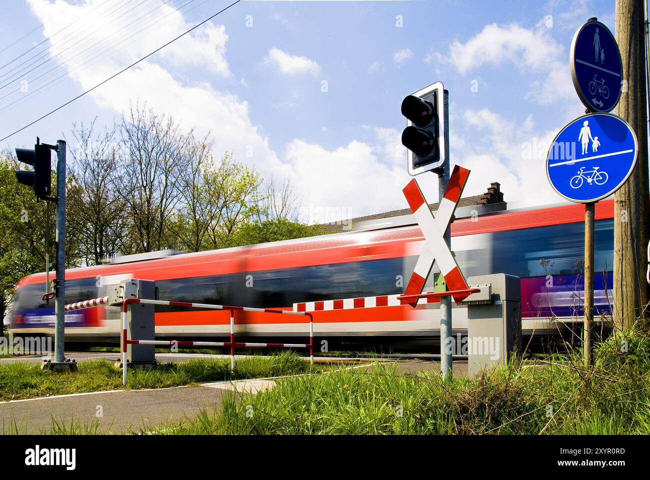 Regional train passes level crossing Stock Photo - Alamy
