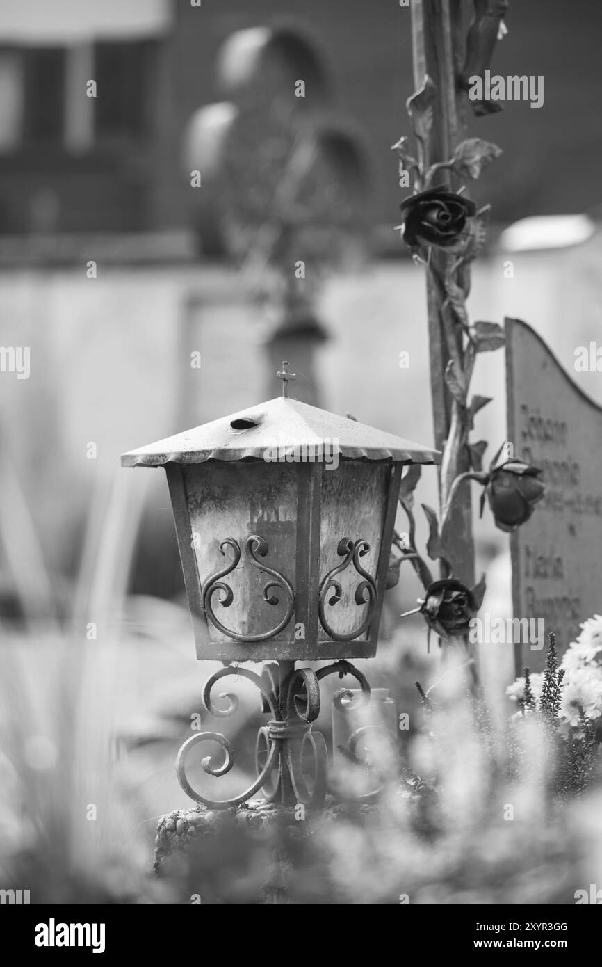 Candle in an iron lantern on a grave at a cemetery Stock Photo - Alamy