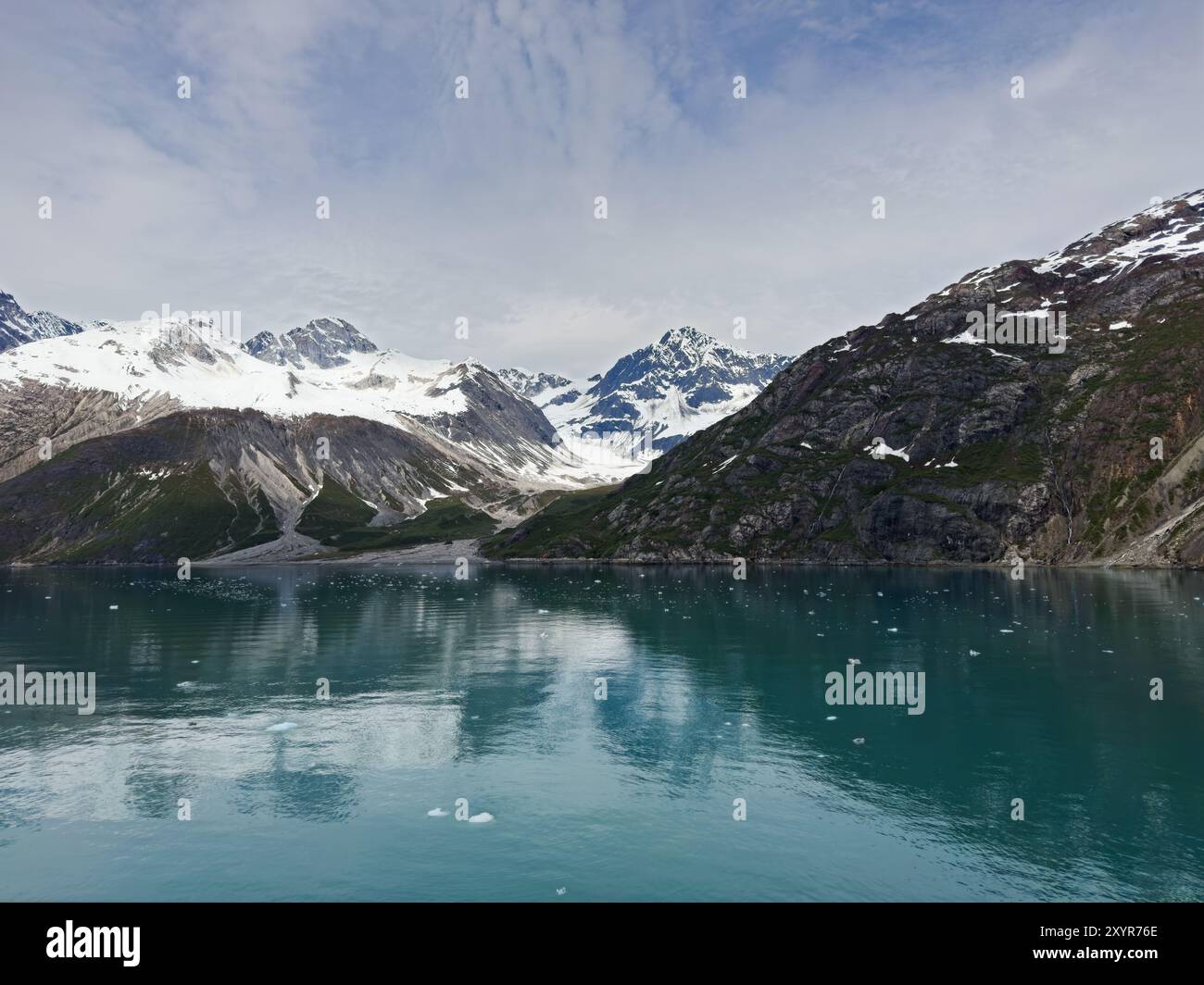 Snowy mountains and turquoise water with floating ice are typical ...