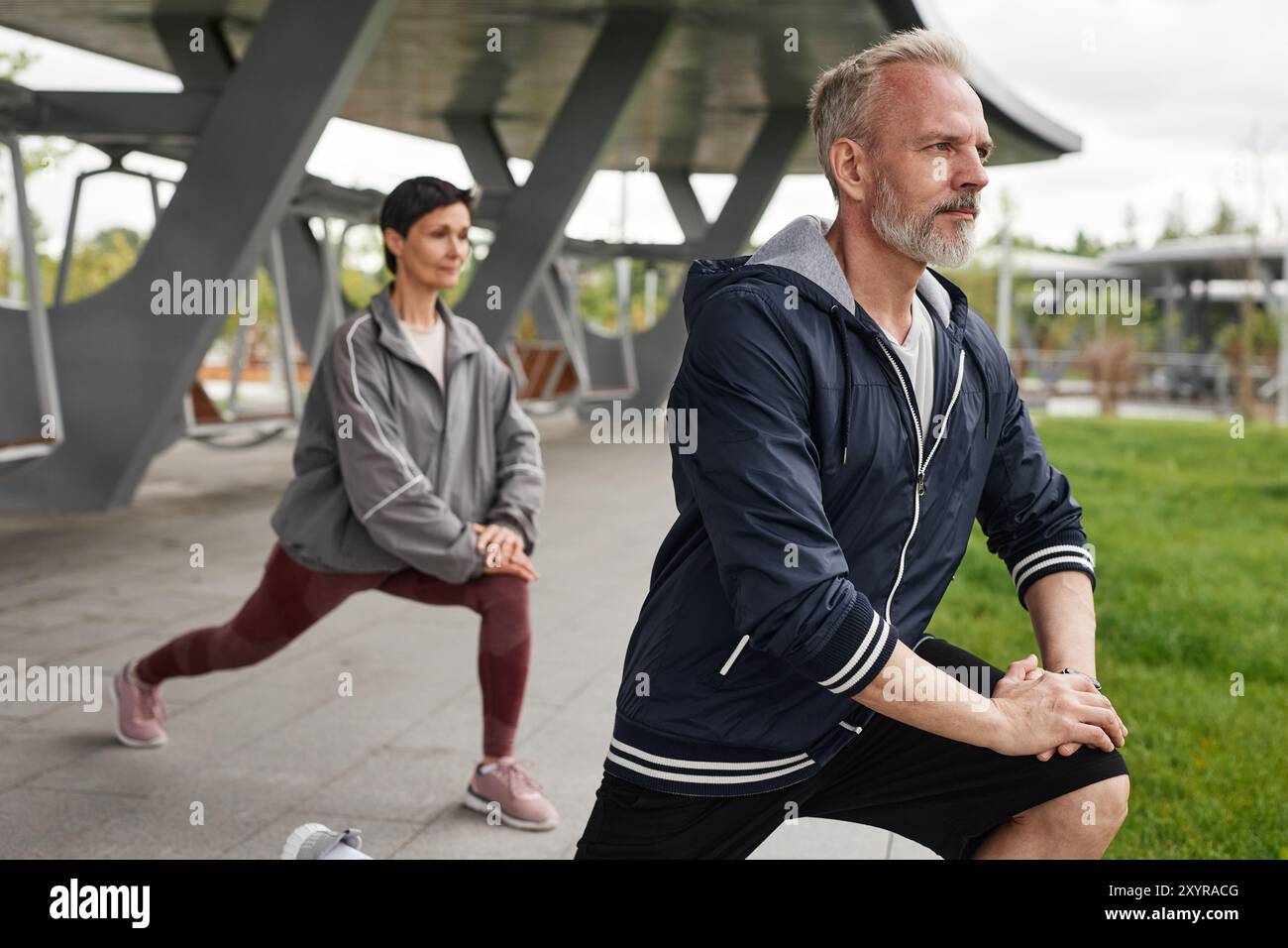 Fit senior man holding static lunge position strengthening leg muscles ...