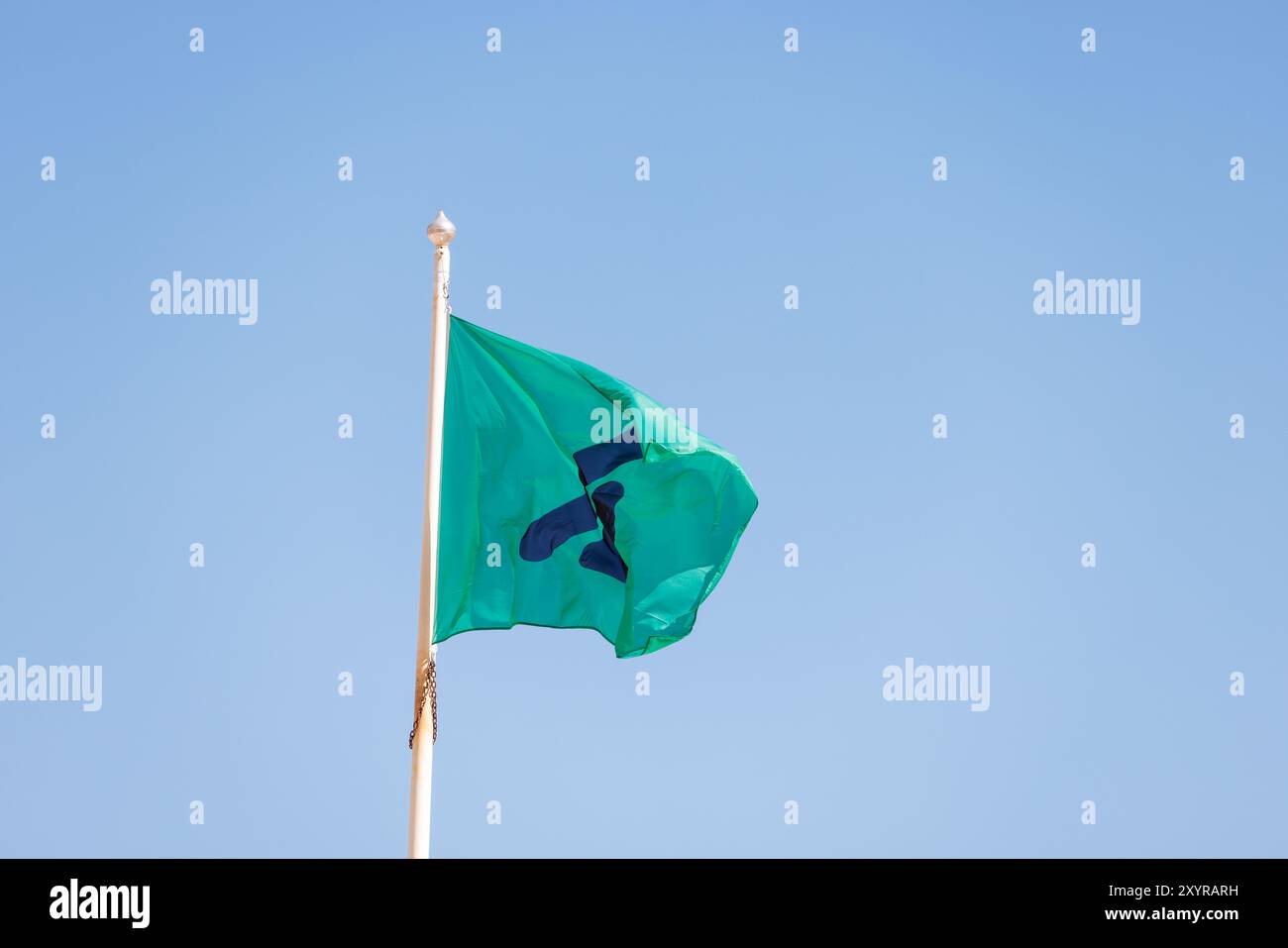 Photo of a green warning flag on the beaches of Benidorm in Spain ...