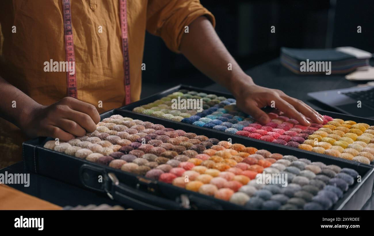 Unrecognizable man fashion designer couturier tailor dressmaker choose ...