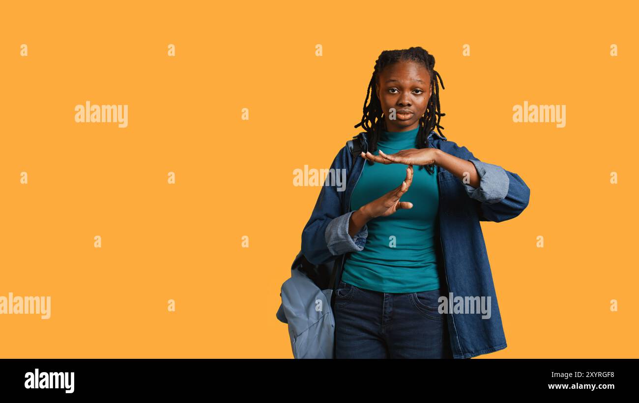 Portrait of assertive woman asking for timeout, doing hand gestures ...