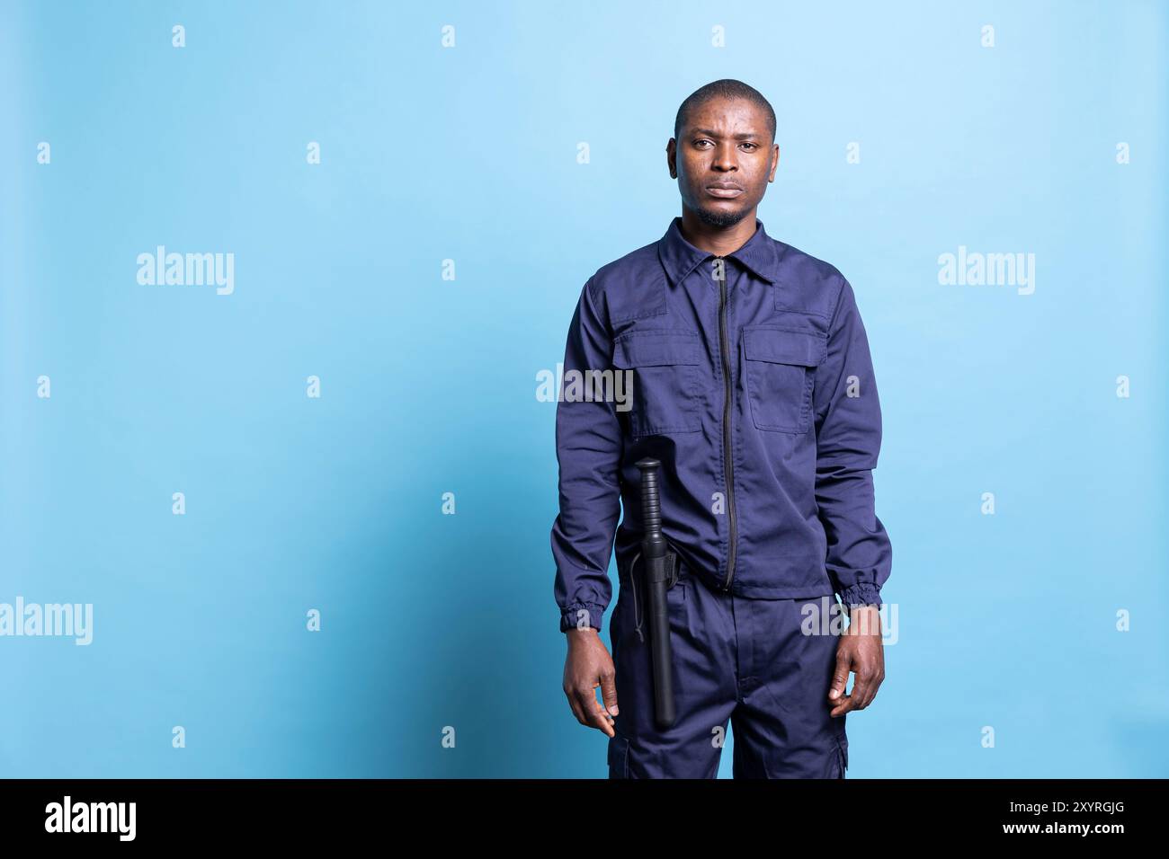 Portrait of african american security officer posing in studio, wearing ...