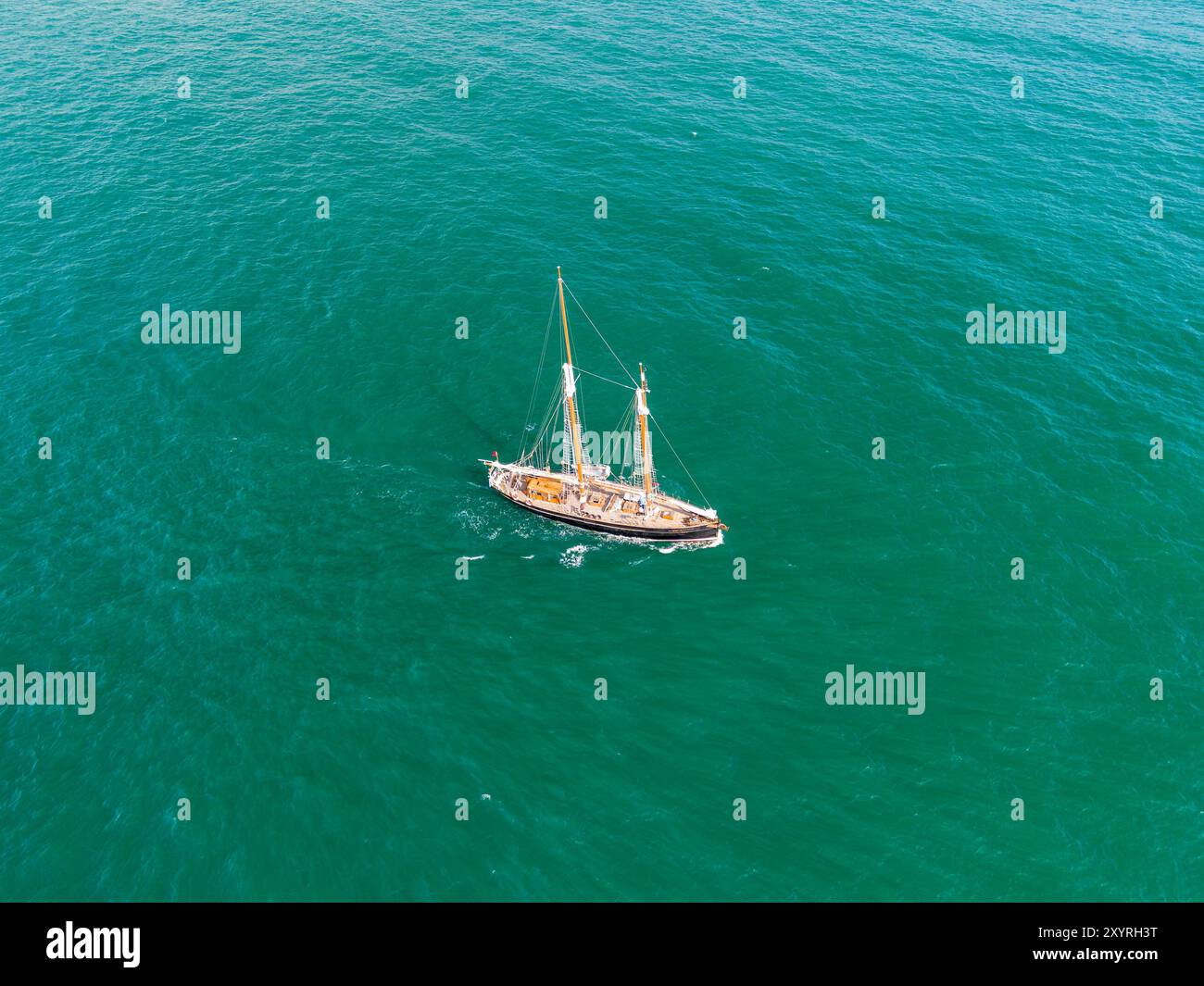 Classic sailing yacht is gracefully navigating the mesmerizing ...