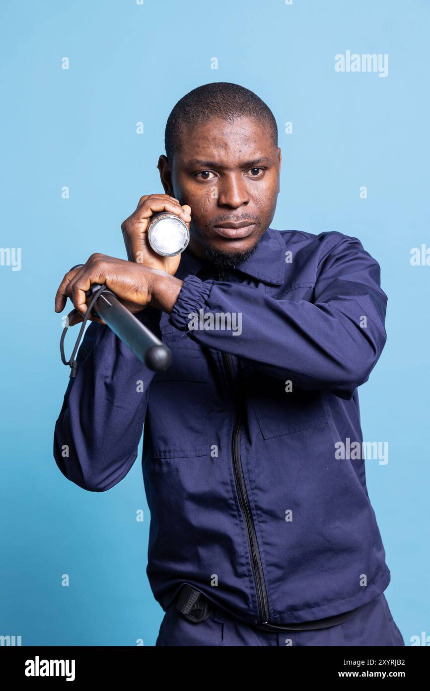 Serious security agent doing a control sweep in the dark with his ...