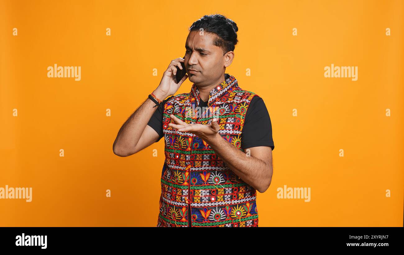 Indian man discussing with best friend over telephone call using ...
