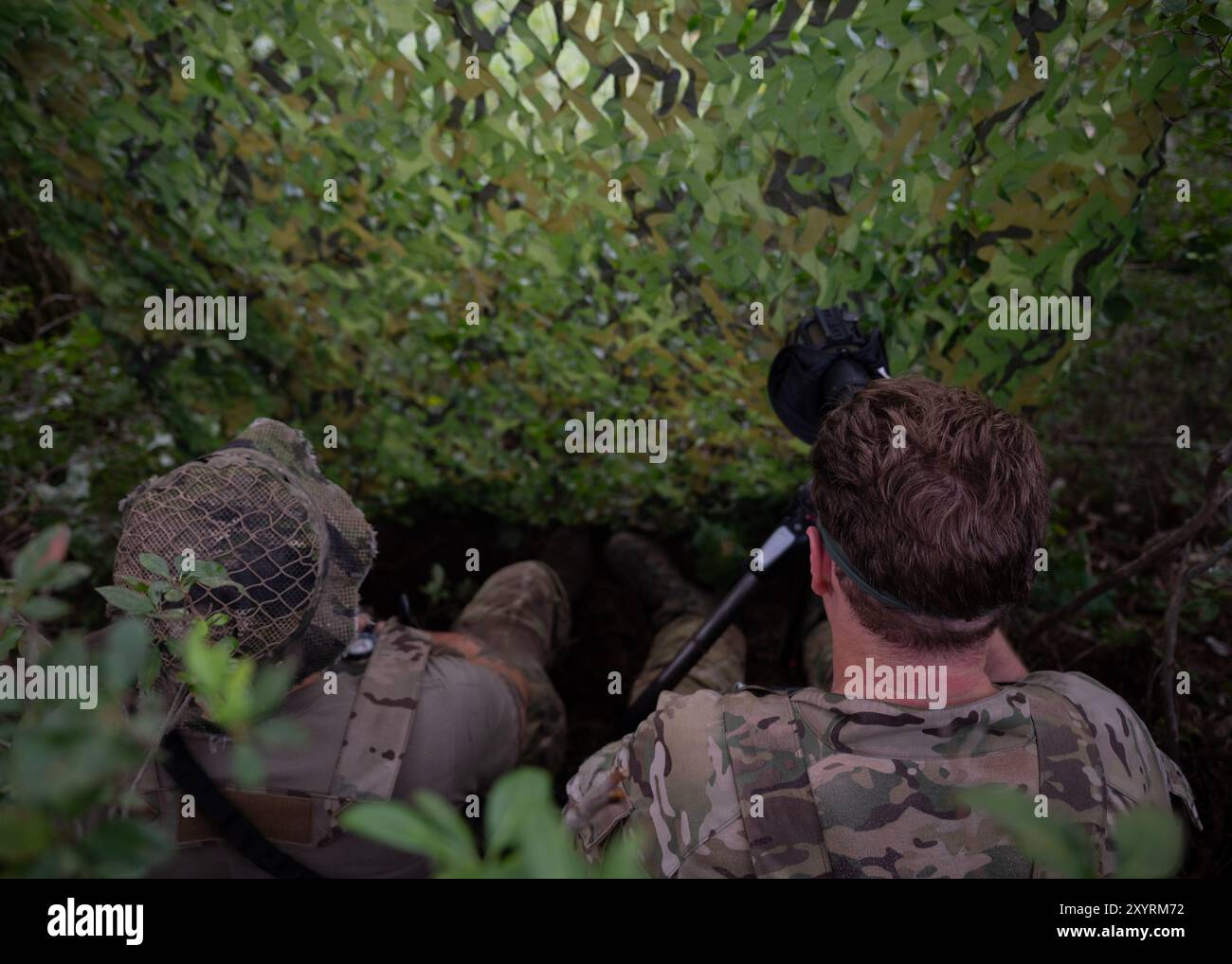 U.S. Army Green Berets identify and observe simulated targets from a ...