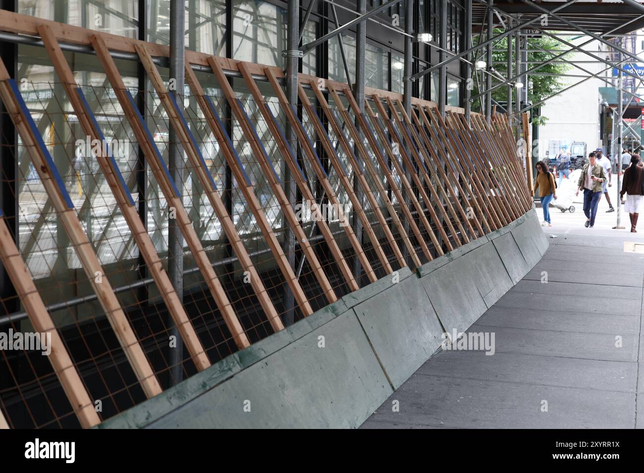 A barricade made of wood and wire is placed around a building in ...