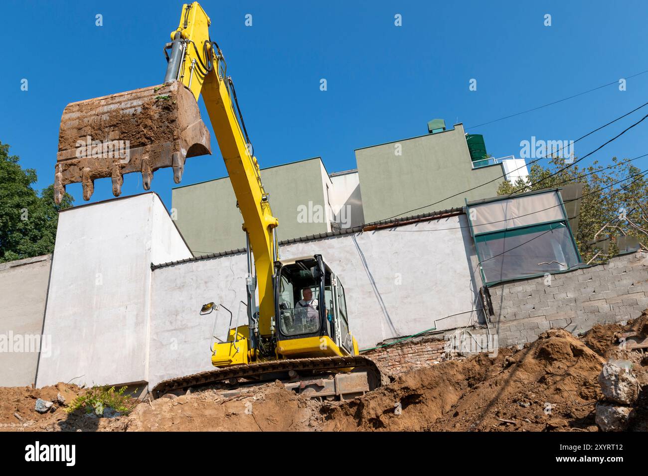 Process of demolition of old building dismantling. Excavator breaking ... Process of demolition of old building dismantling. Excavator breaking ...