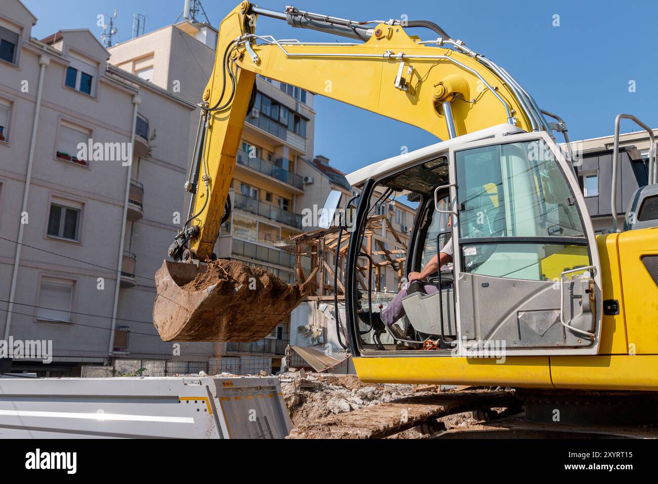 Process of demolition of old building dismantling. Excavator breaking ... Process of demolition of old building dismantling. Excavator breaking ...