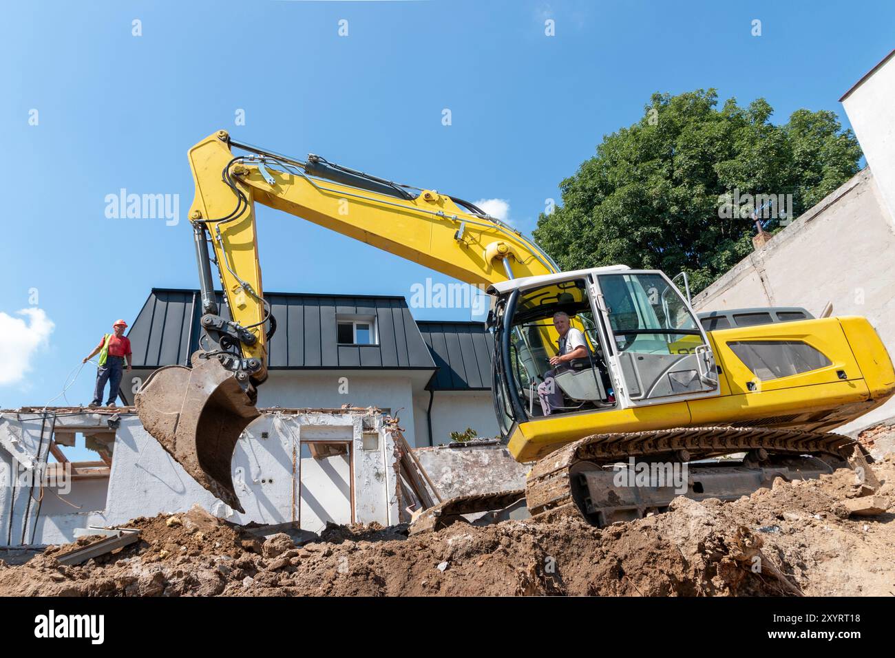 Process of demolition of old building dismantling. Excavator breaking ... Process of demolition of old building dismantling. Excavator breaking ...