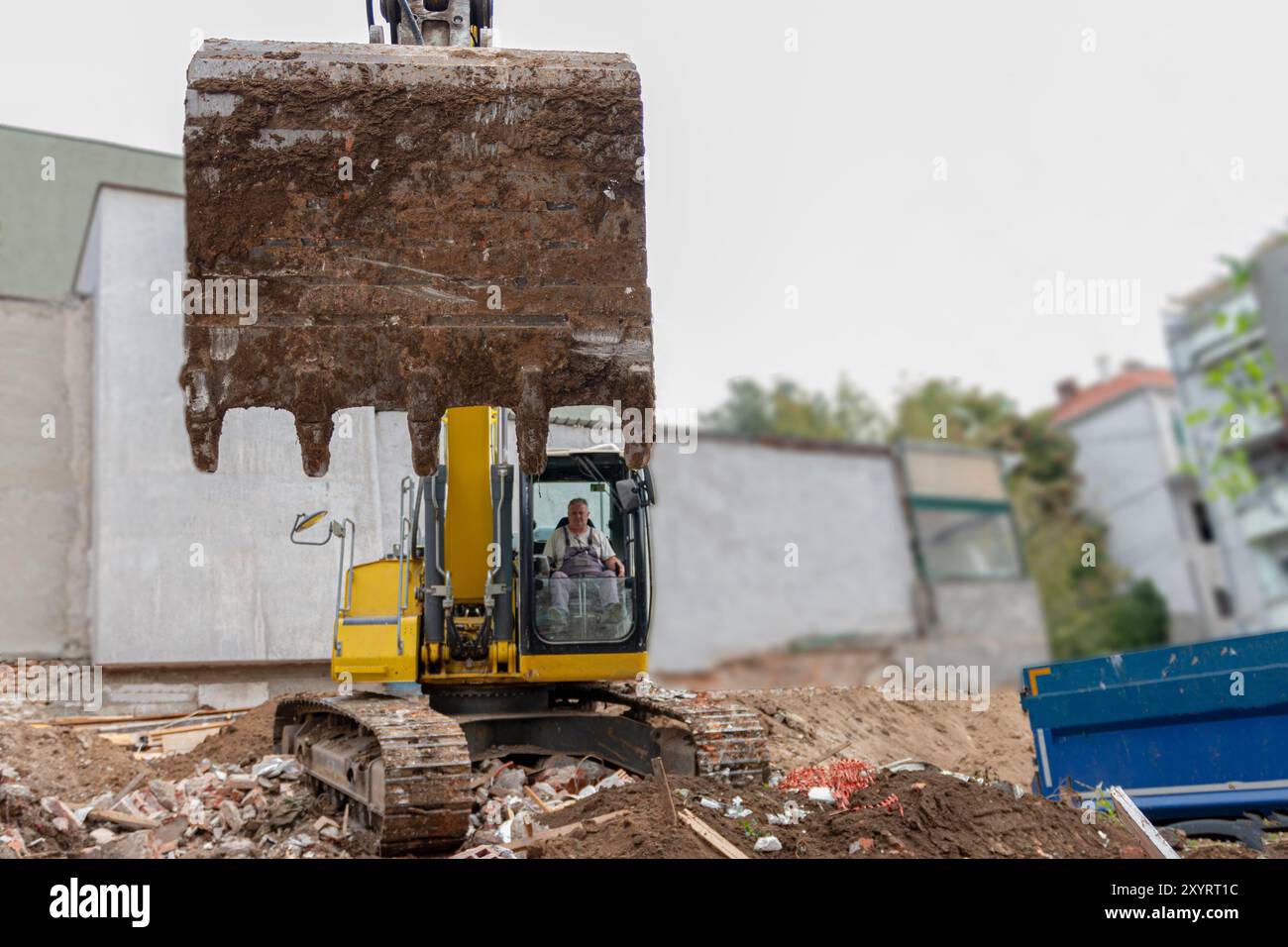 Process of demolition of old building dismantling. Excavator breaking ... Process of demolition of old building dismantling. Excavator breaking ...