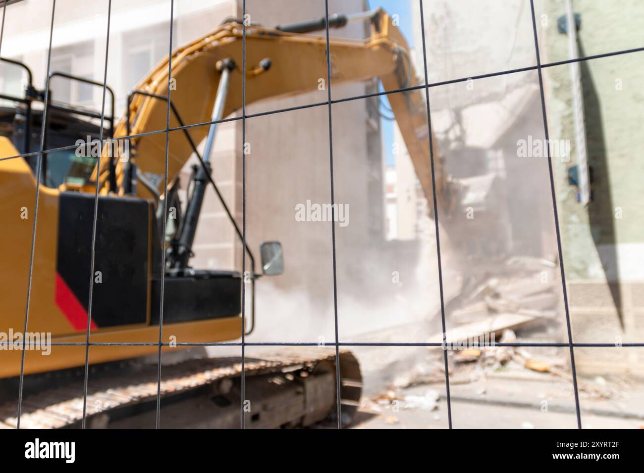 Process of demolition of old building dismantling. Excavator breaking ...