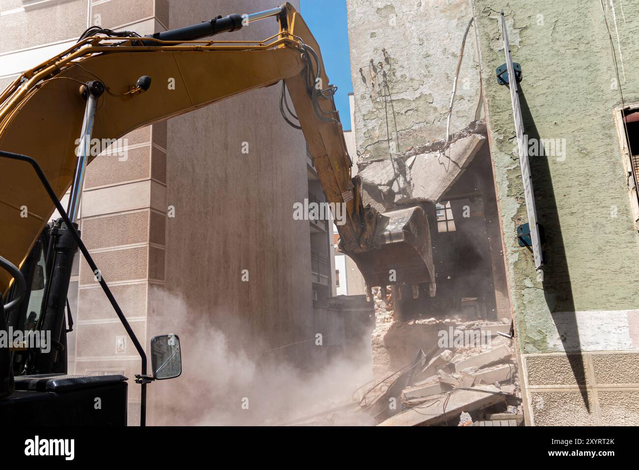 Process of demolition of old building dismantling. Excavator breaking ...