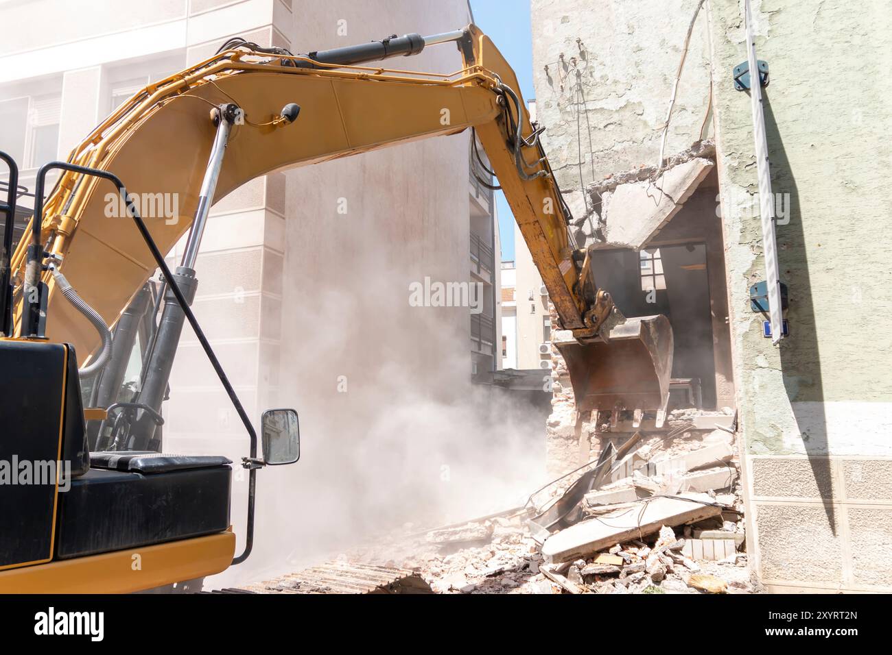 Process of demolition of old building dismantling. Excavator breaking ...