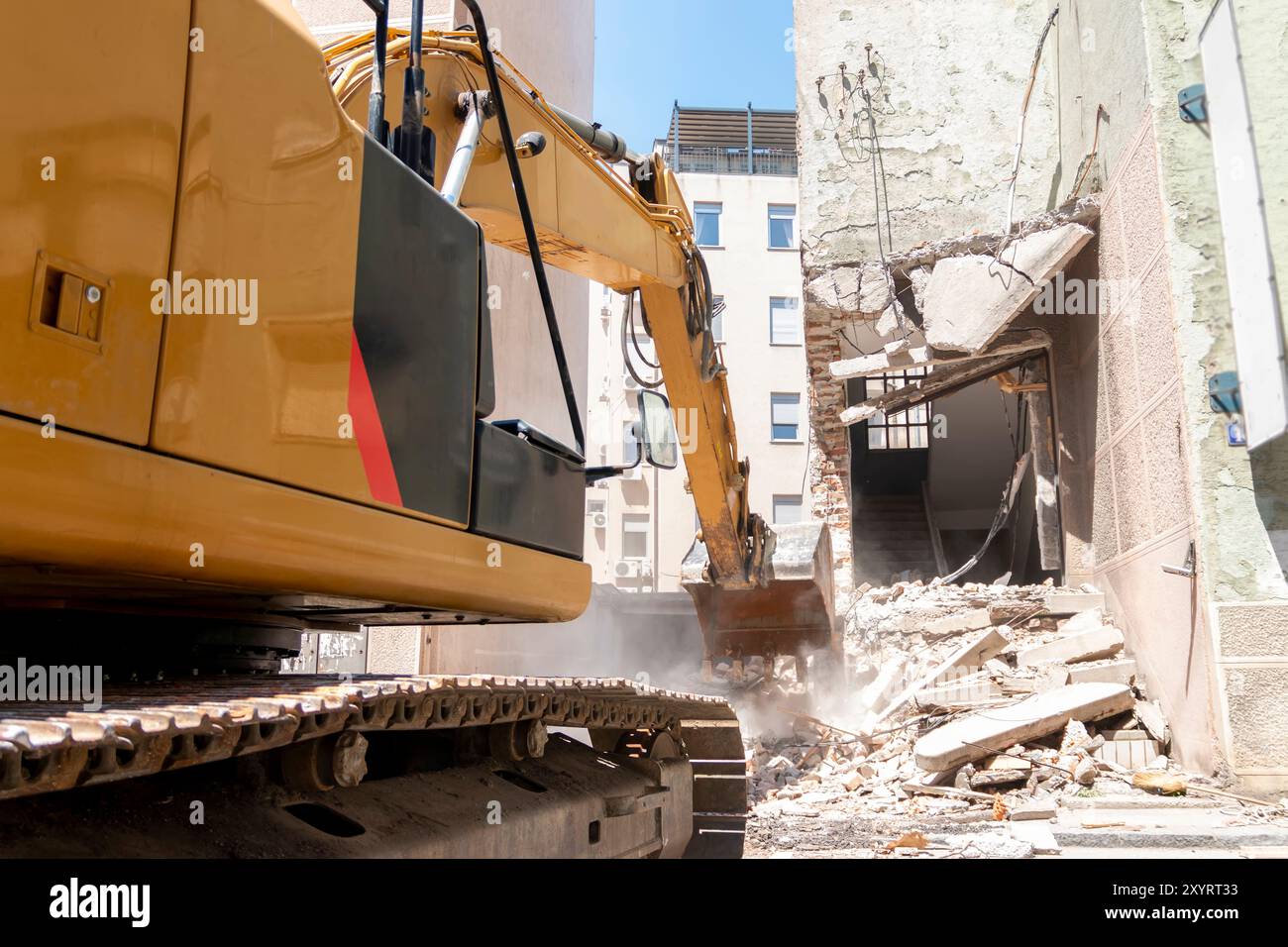 Process of demolition of old building dismantling. Excavator breaking ...