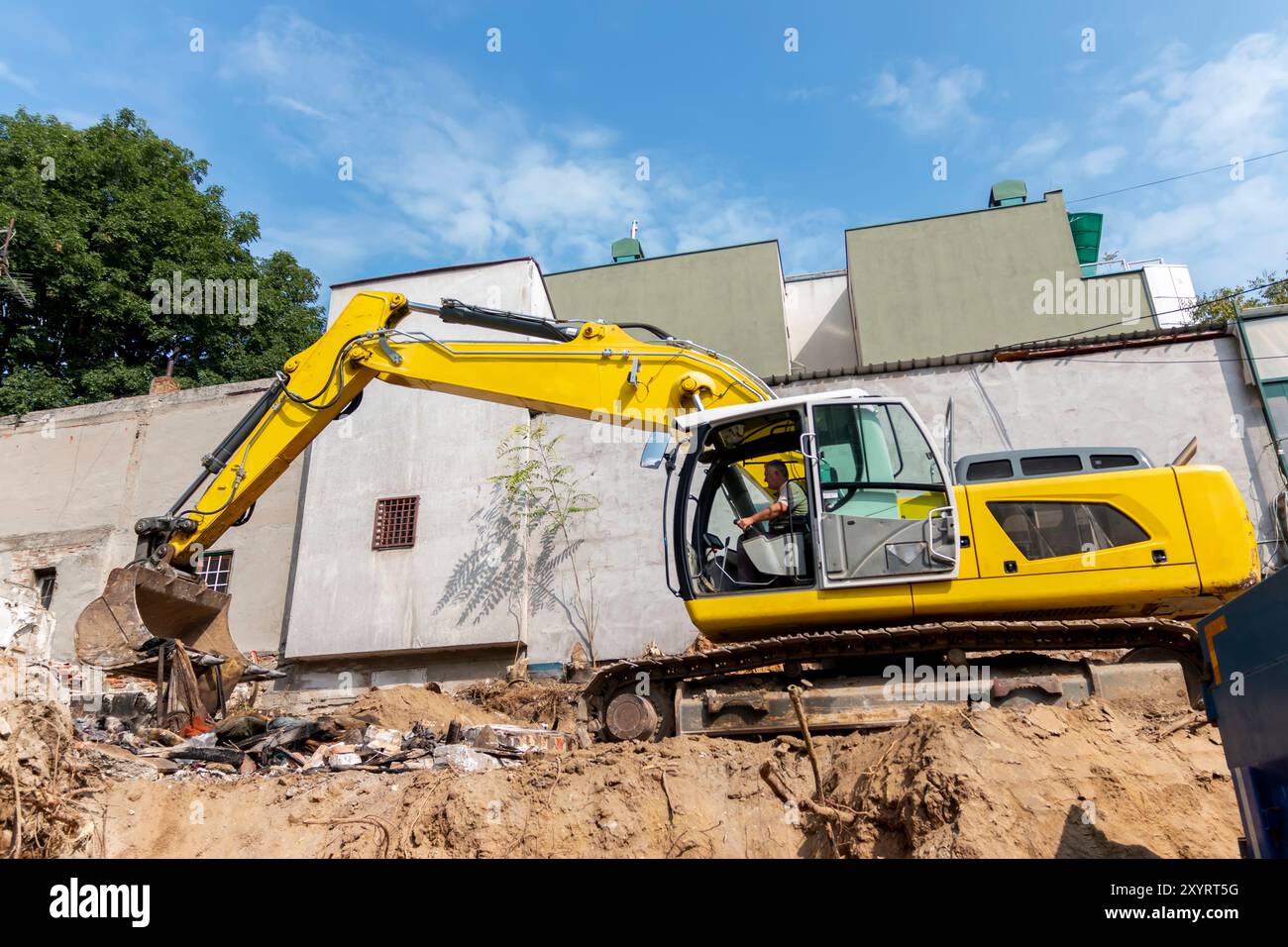 Process of demolition of old building dismantling. Excavator breaking ...