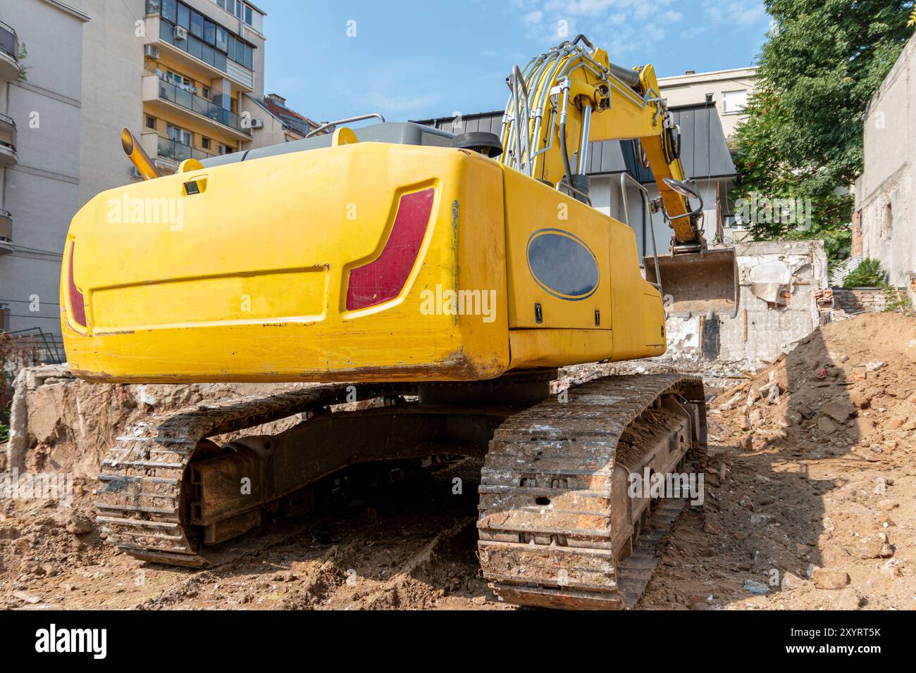Process of demolition of old building dismantling. Excavator breaking ...