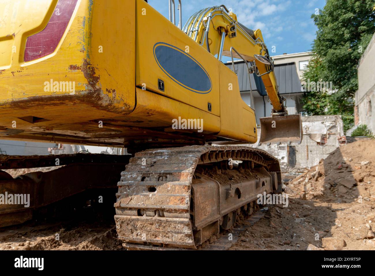 Process of demolition of old building dismantling. Excavator breaking ...