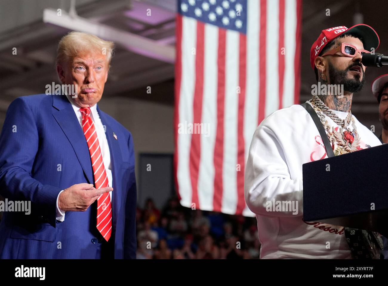 Republican presidential nominee former President Donald Trump listens ...