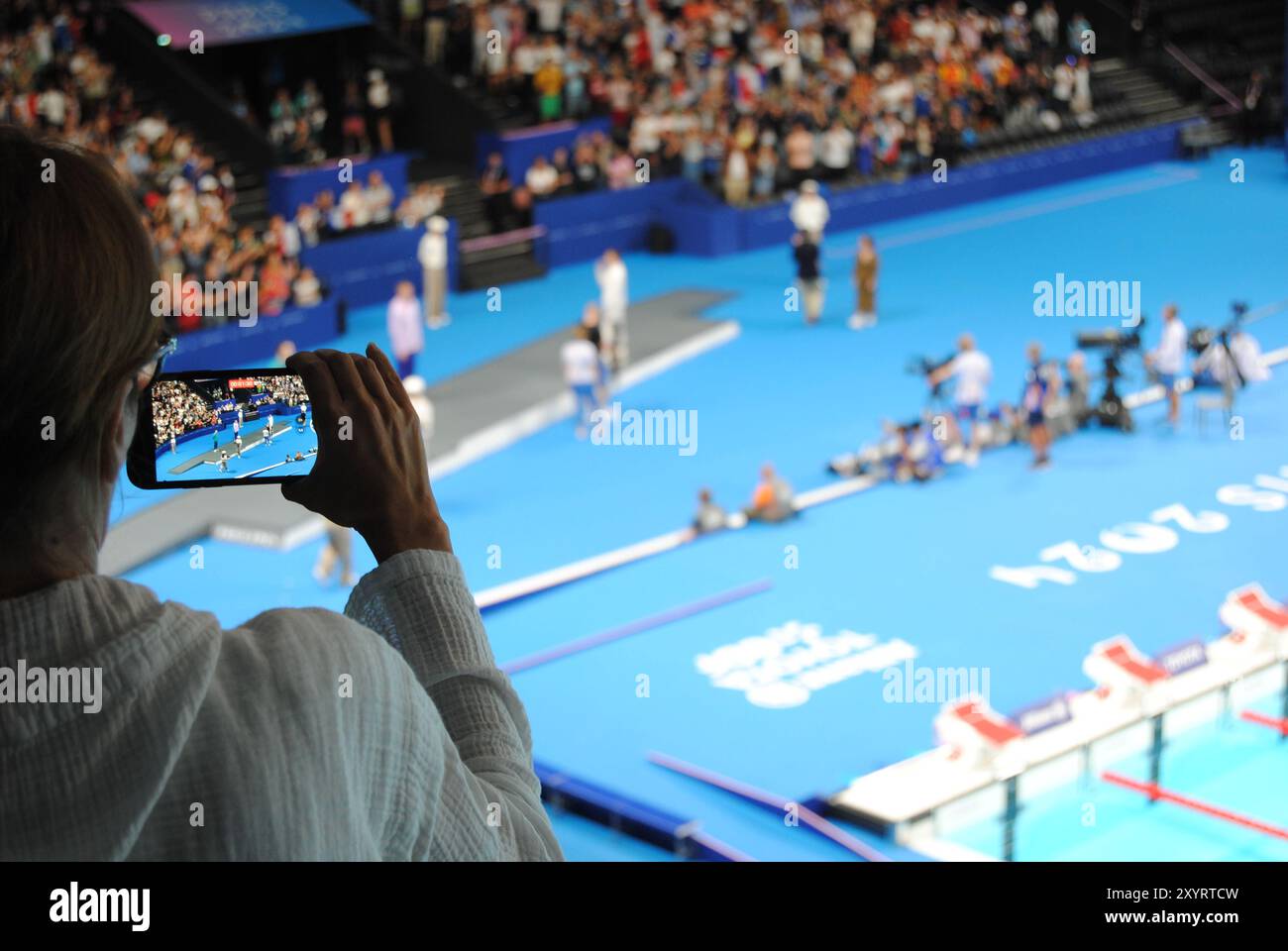 Nanterre, France - August 30 2024: A fan records a Para Swimming ...