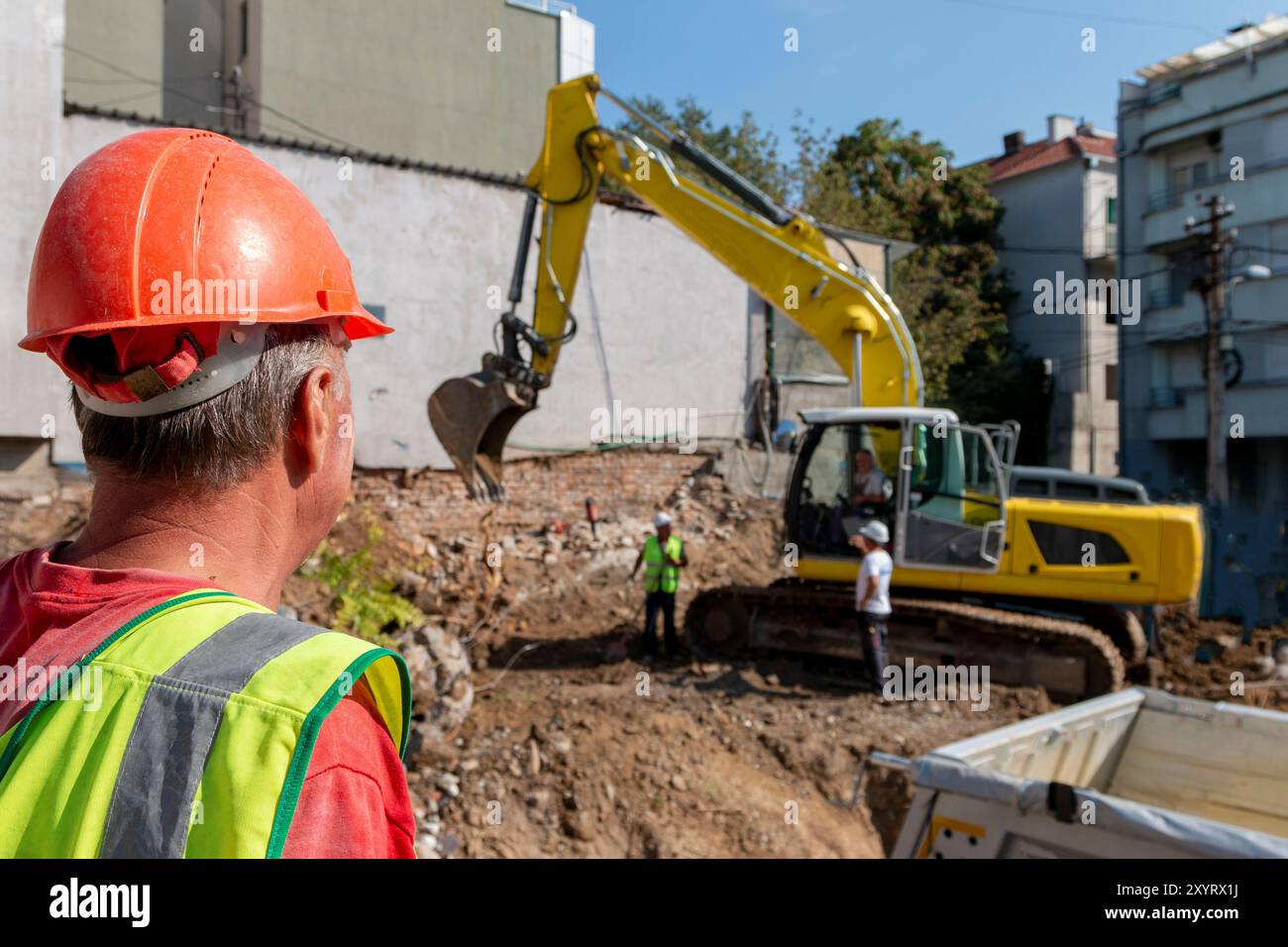 Site manager standing at the construction site of a private property ...