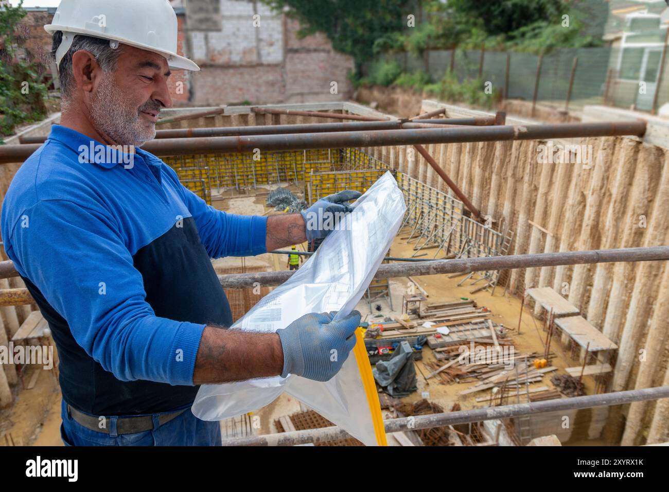 Engineer checking blueprint work hi-res stock photography and images ...