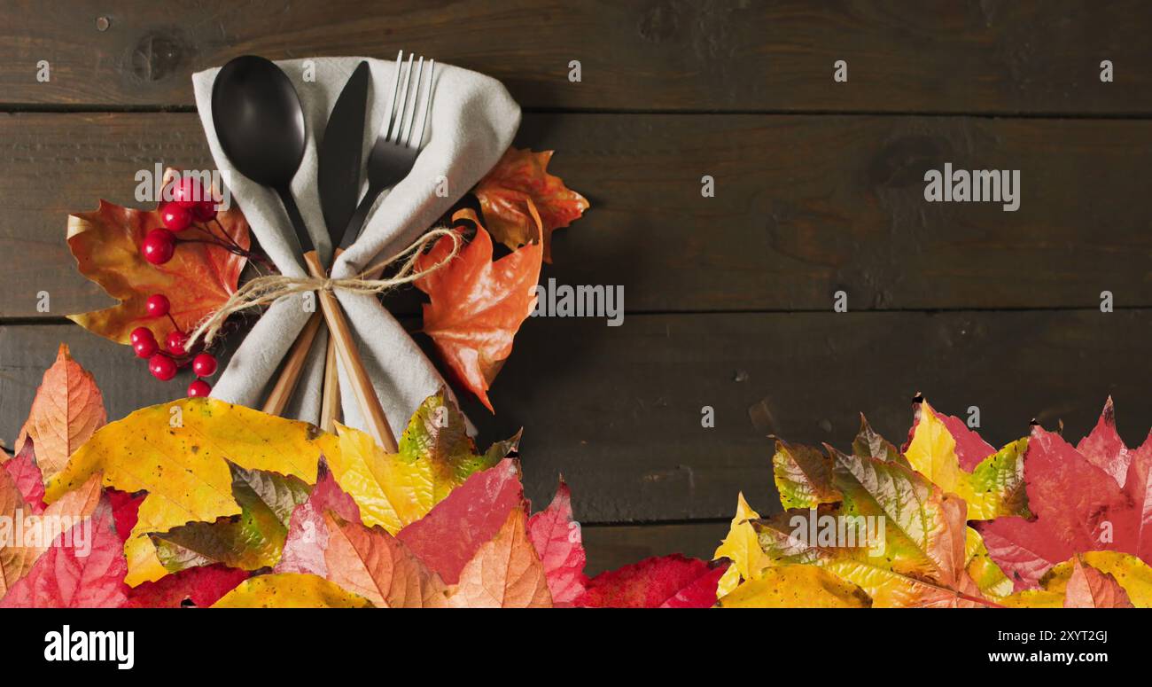 Image of autumn leaves over thanksgiving dinner place setting ...