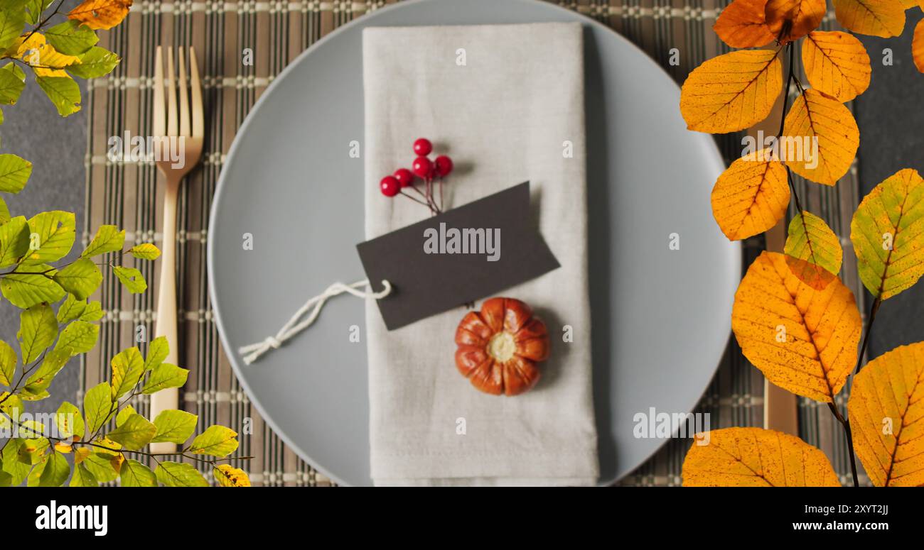 Image of autumn leaves over thanksgiving dinner place setting ...