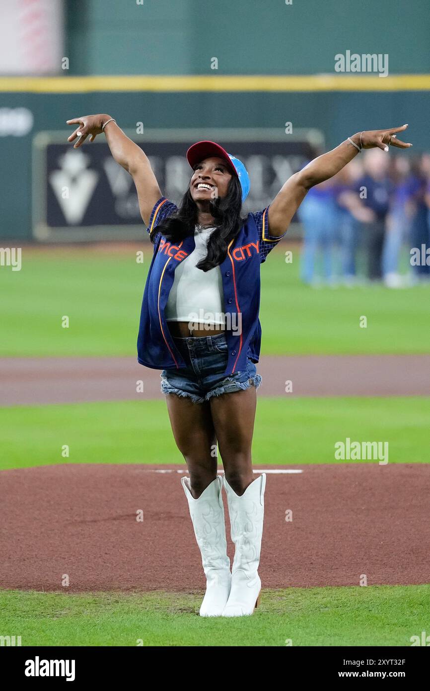 Olympic gymnast Simone Biles salutes after throwing out the ceremonial ...