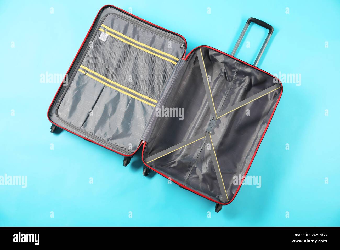 Open empty suitcase for travelling on light blue background, top view ...