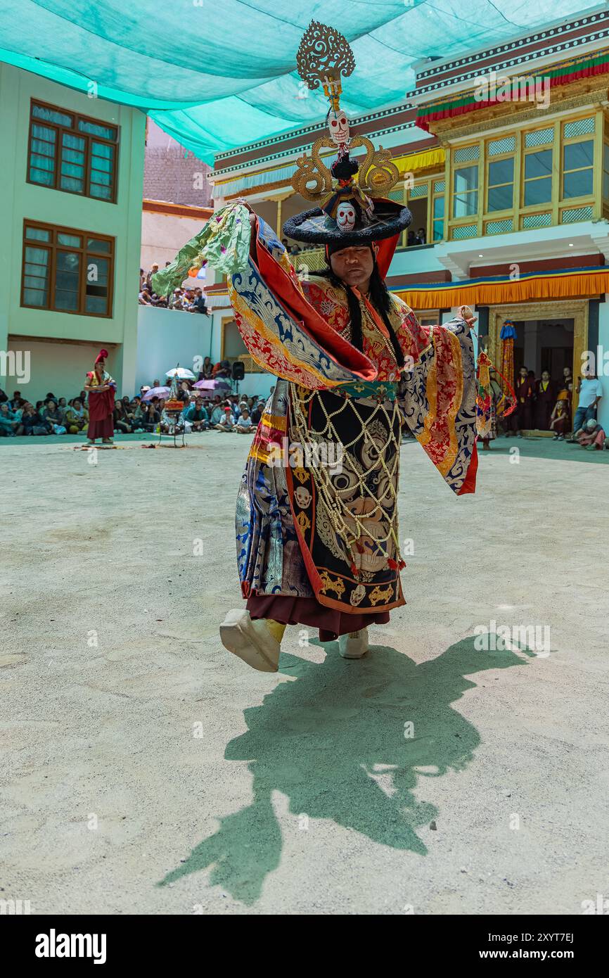 Ladakhi monk performing dance in an event wearing traditional costume ...