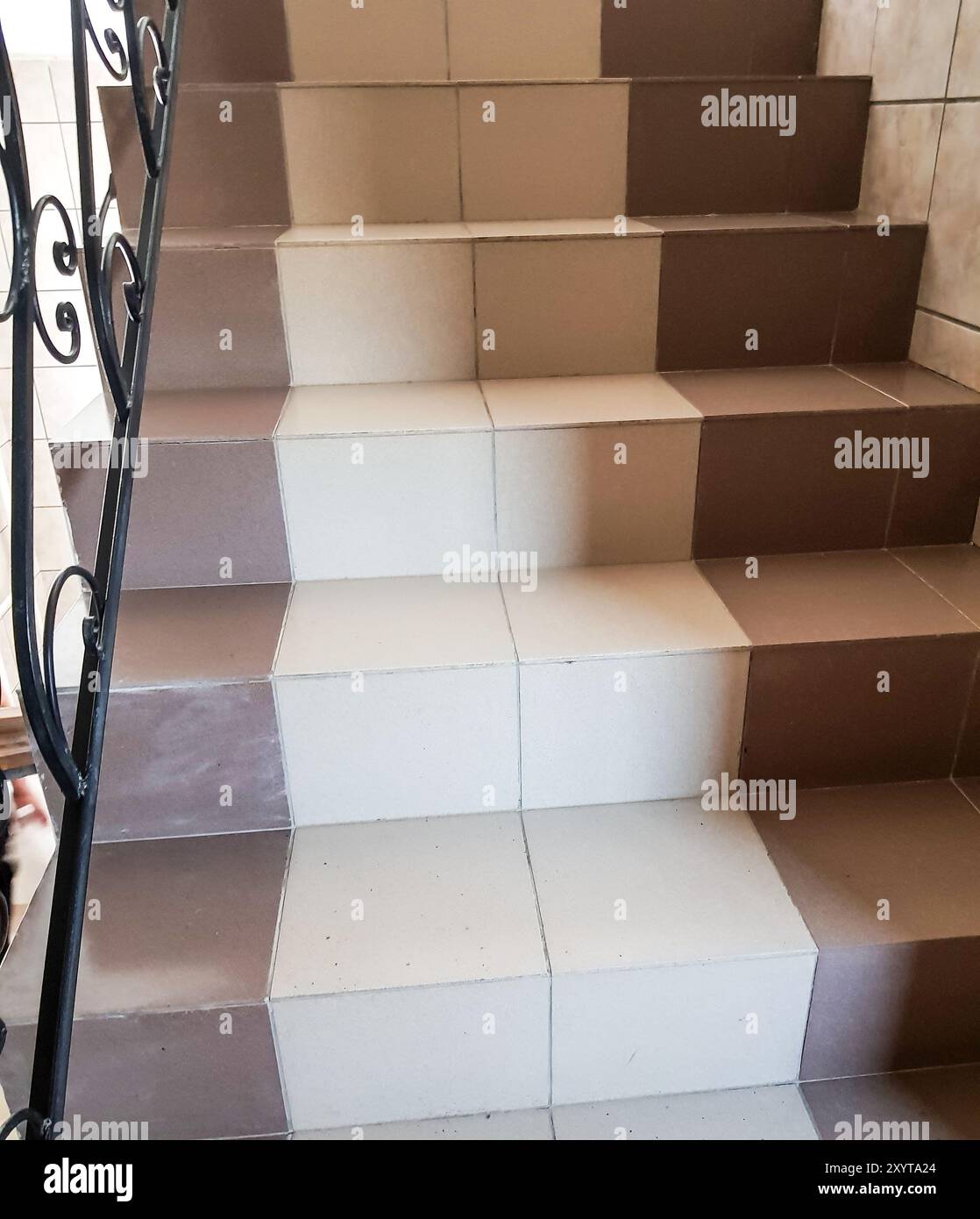 Ceramic tiled steps on the stairs inside a modern room, brown and beige ...