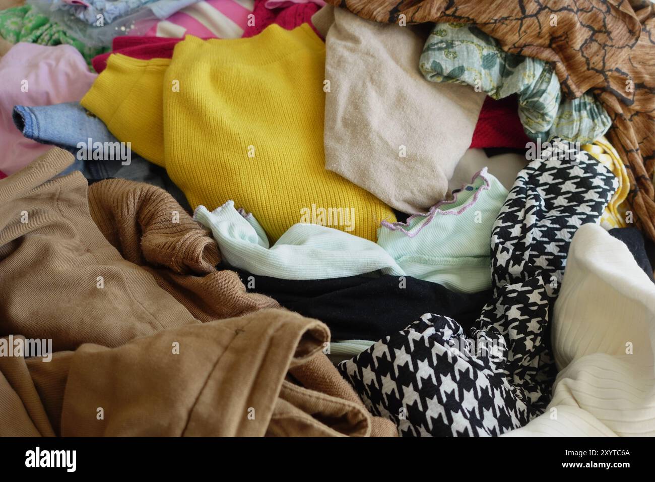 A Colorful and Textured Pile of Various Clothing Perfect for Fashion ...