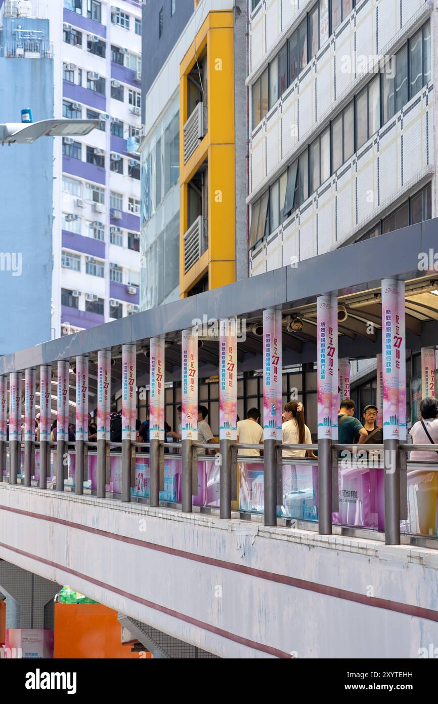 Hong Kong, China - July 03, 2024 : A pedestrian overpass with railings ...