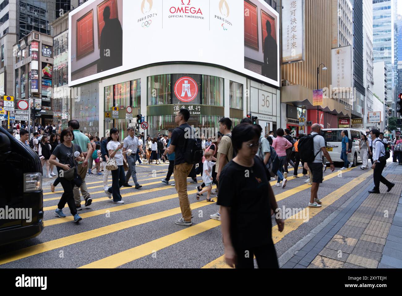 Hong Kong, China - July 03, 2024 : Pedestrians walk across a crosswalk ...