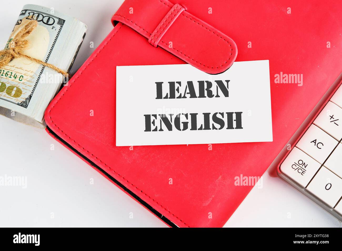 Learn English Text written on a business card on a red business book on ...