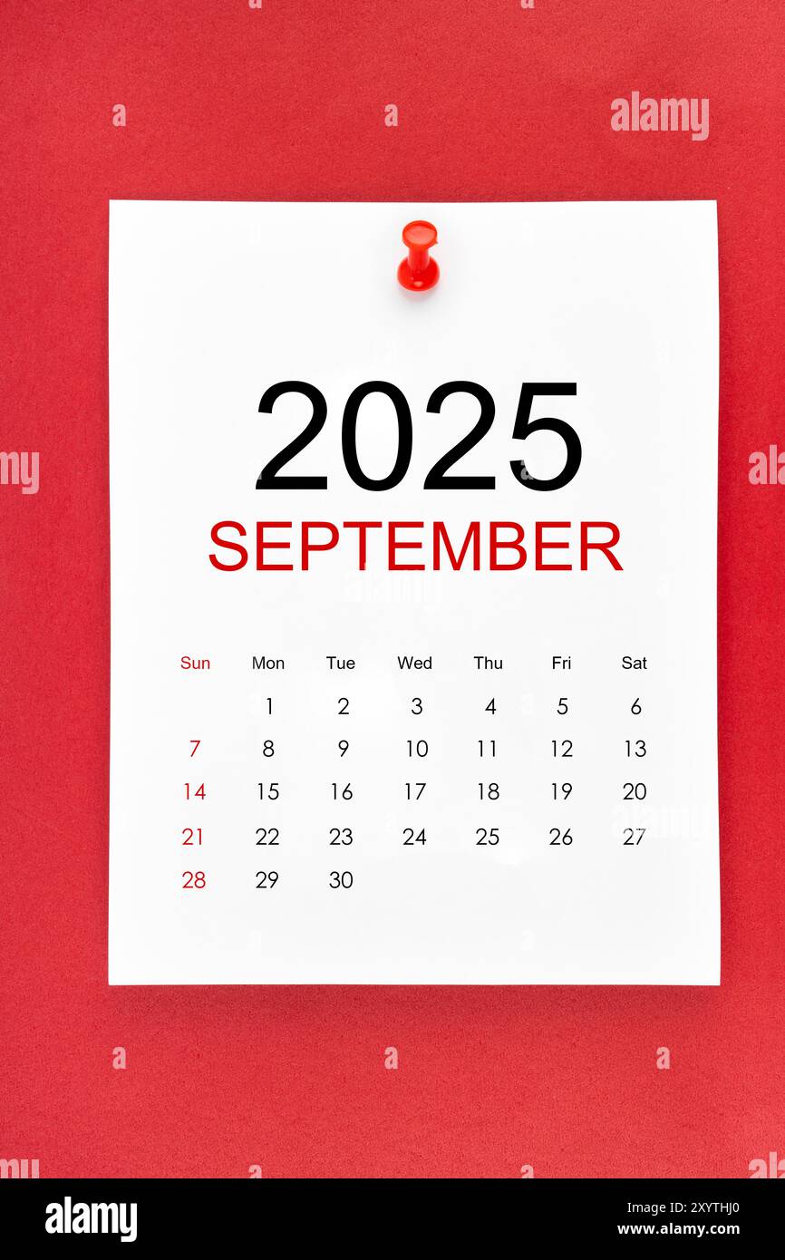 September 2025 calendar page with push pin on red color background ...