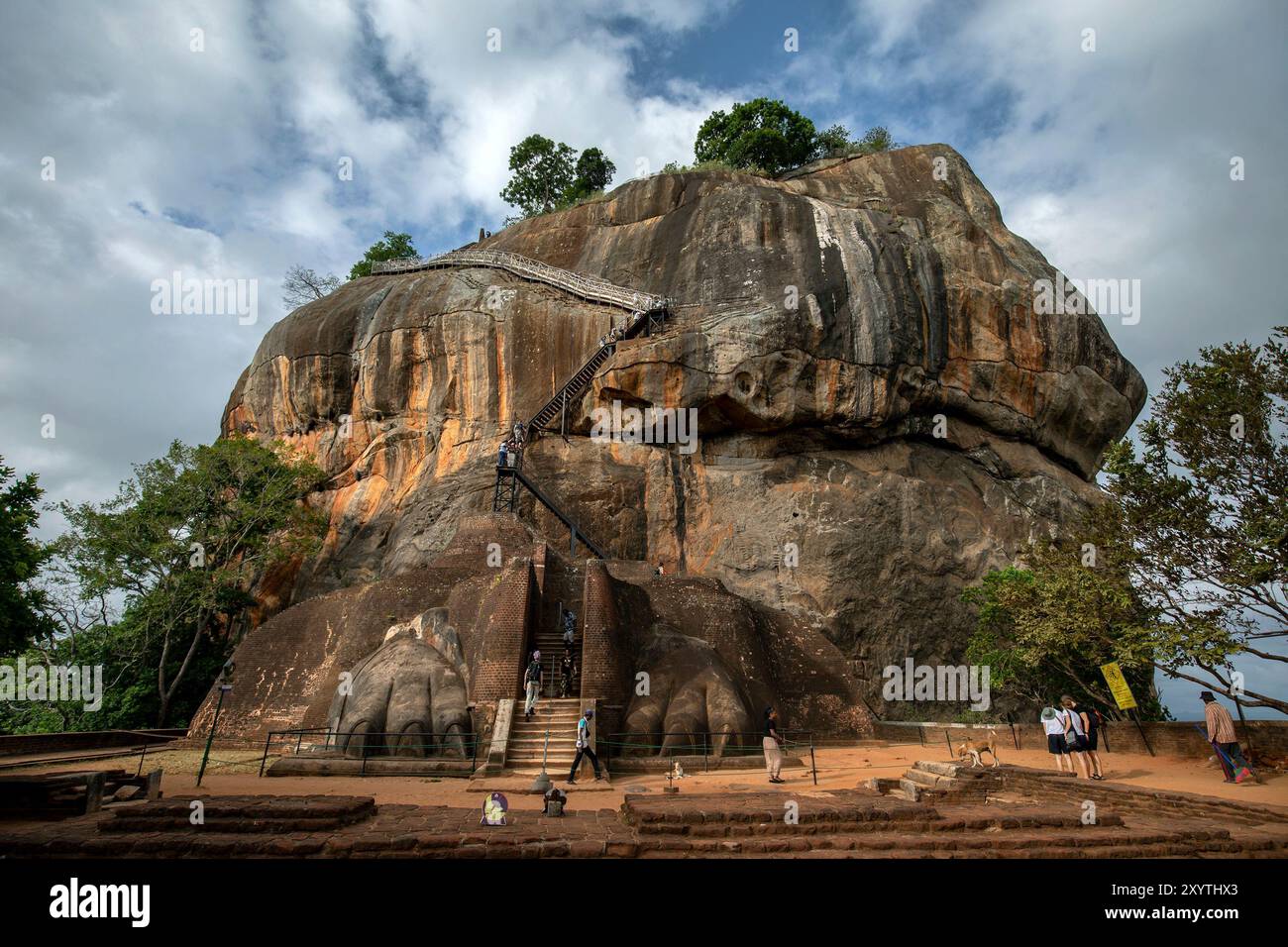 Tourists walk between the Lions Paws on the Lion Platform at Sigiriya ...