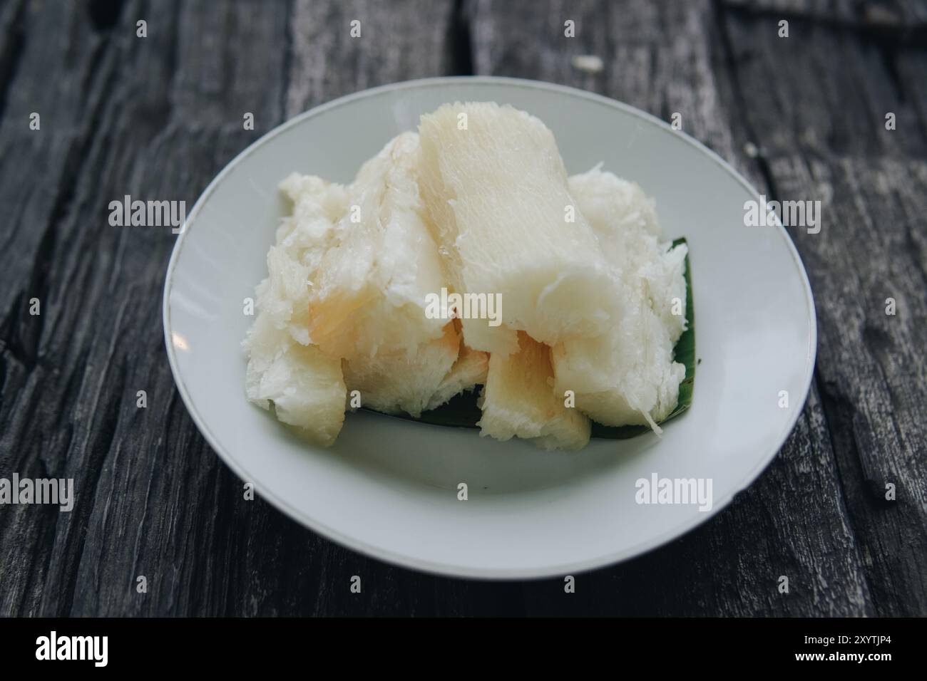 Boiled cassava or telo, Indonesian traditional snack, served on top of ...