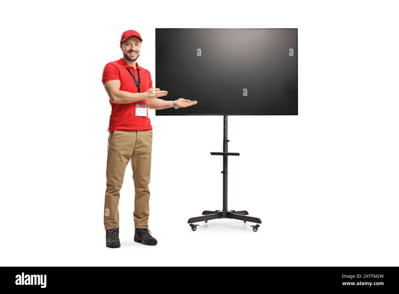 Full length portrait of a shop assistant pointing at a tv screen ...