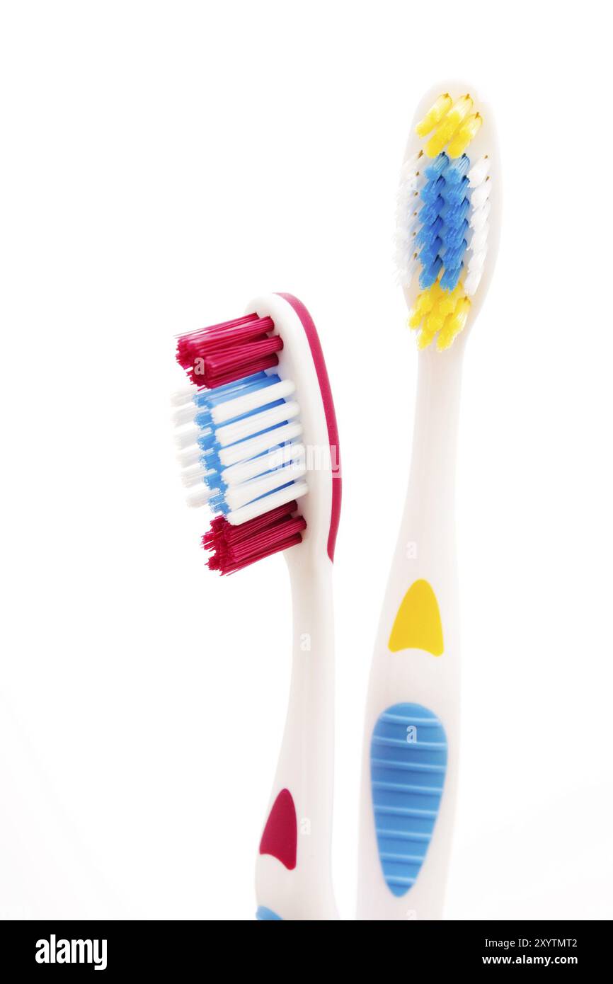 Red and yellow toothbrushes isolated on white Stock Photo - Alamy