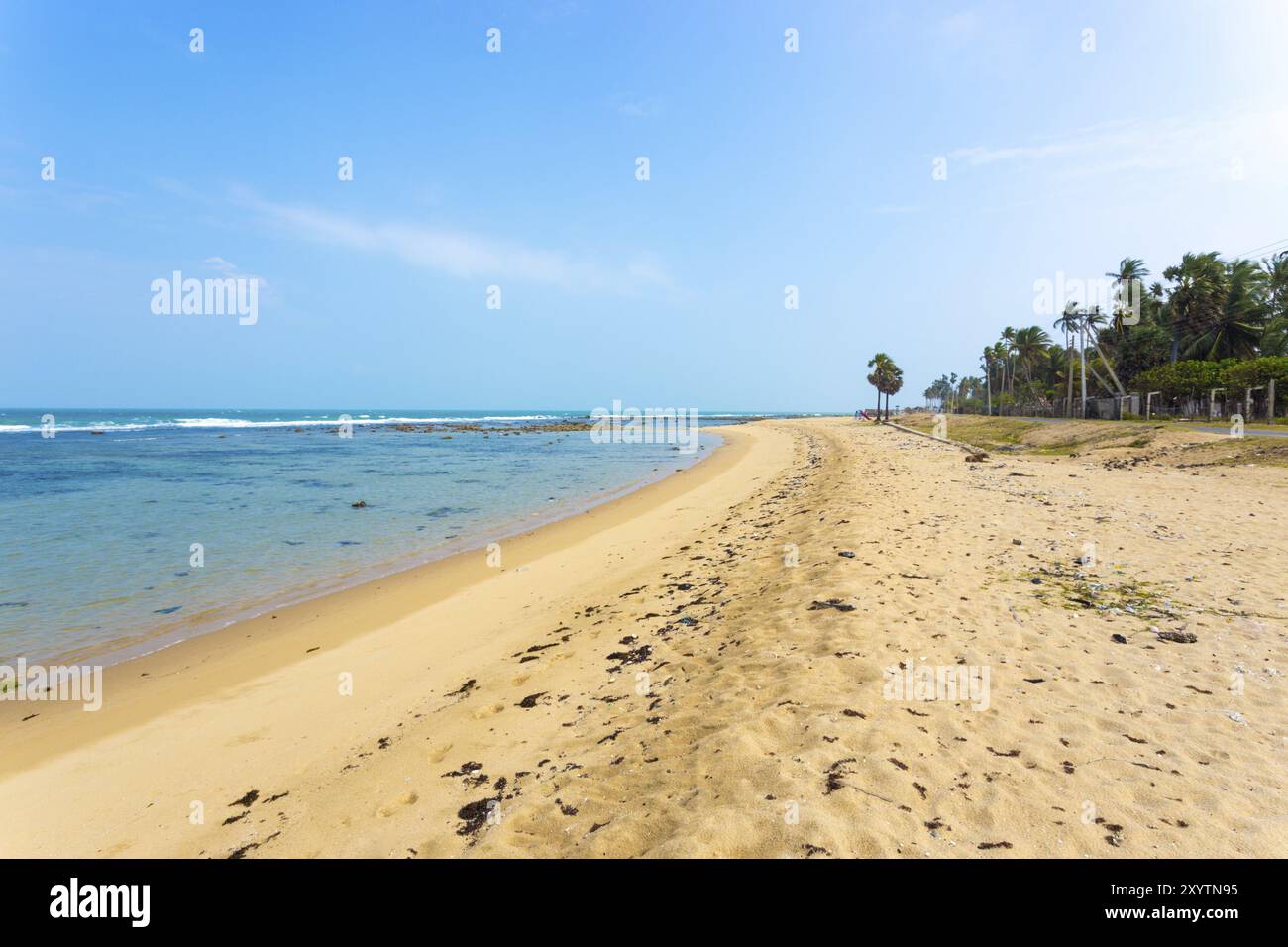 A sand beach with strewn litter seen in Point Pedro, along the northern ...