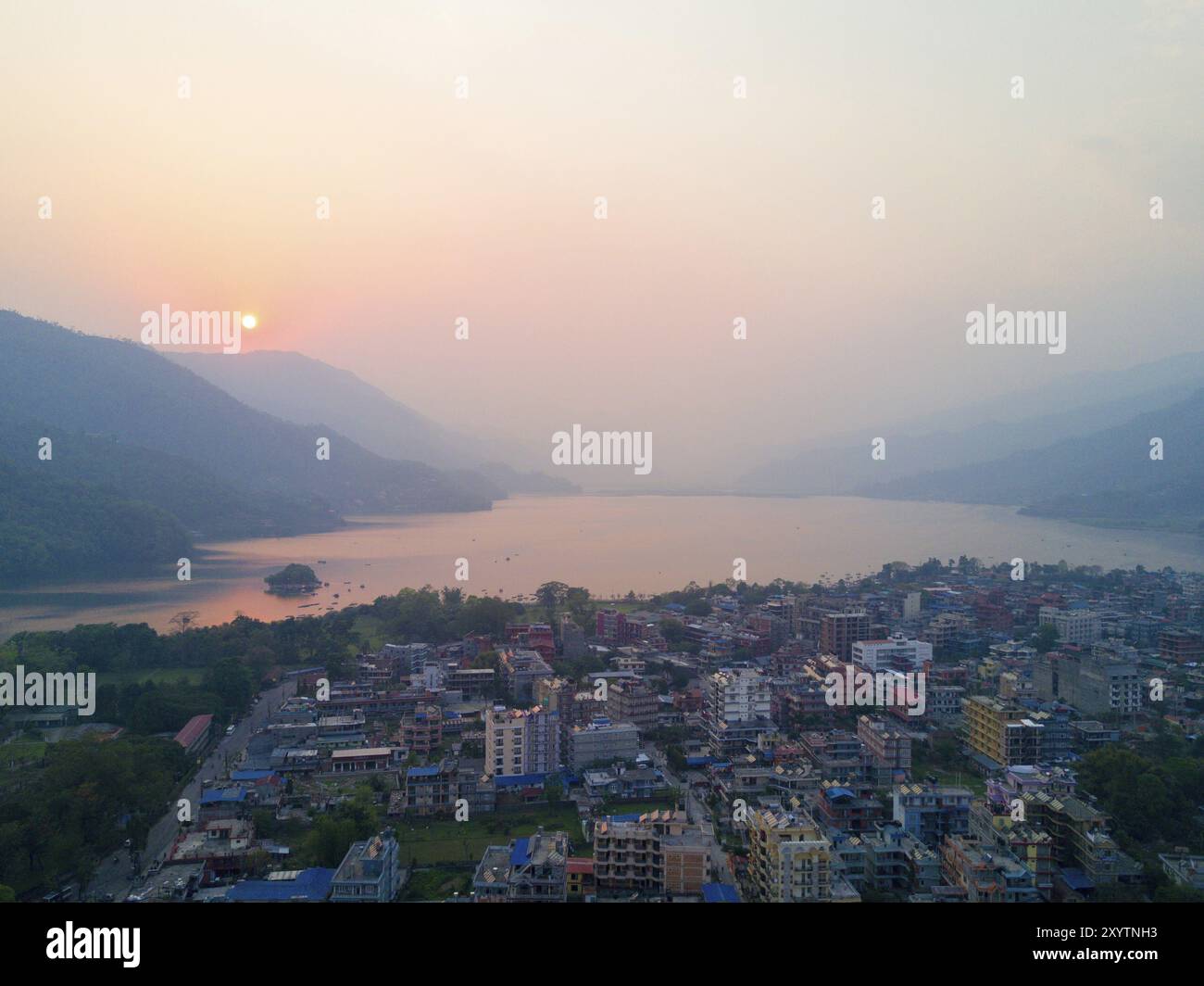 High angle aerial view over Lakeside and Phewa Lake at evening sunset ...