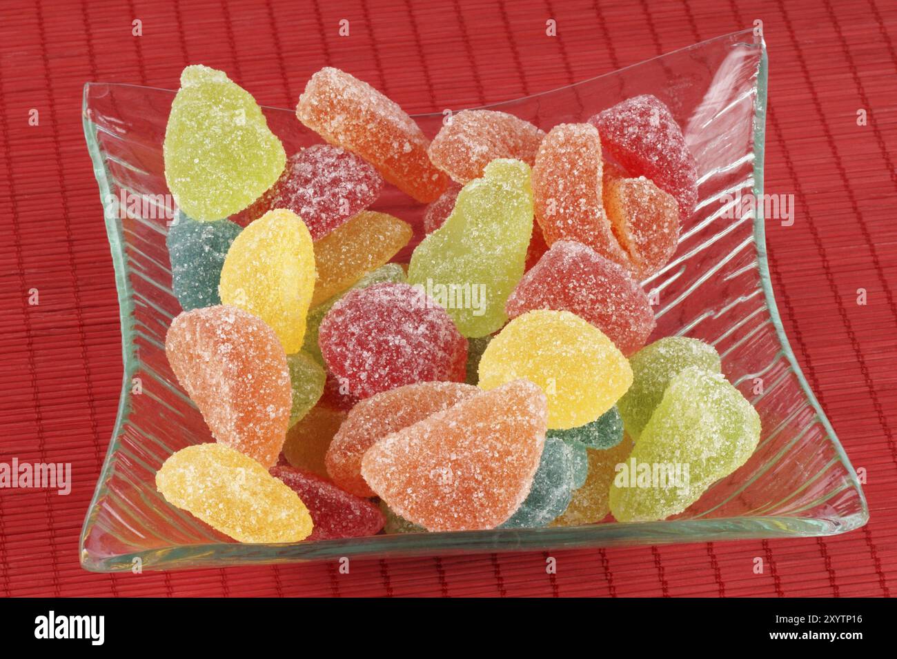 Assorted fruit shaped and flavored jellies in a transparent glass bowl ...
