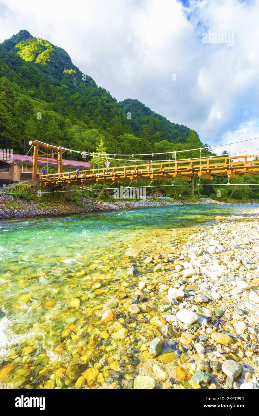Japanese tourists walking over Kappa-Bashi Bridge seen from low angle ...