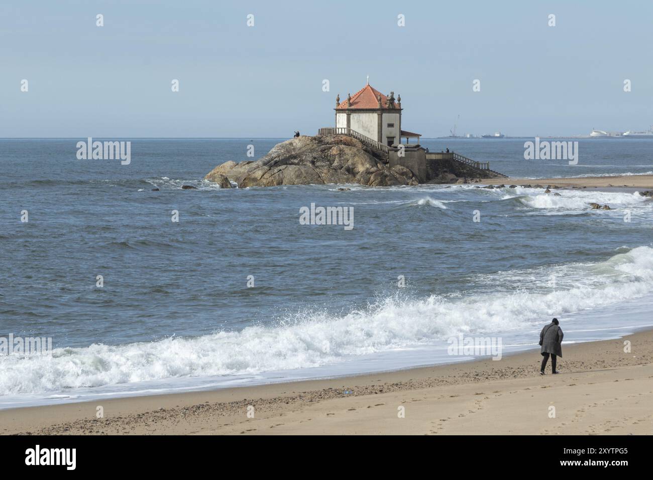 Strollers on the sandy beach with surf and sight Capela do Senhor da ...