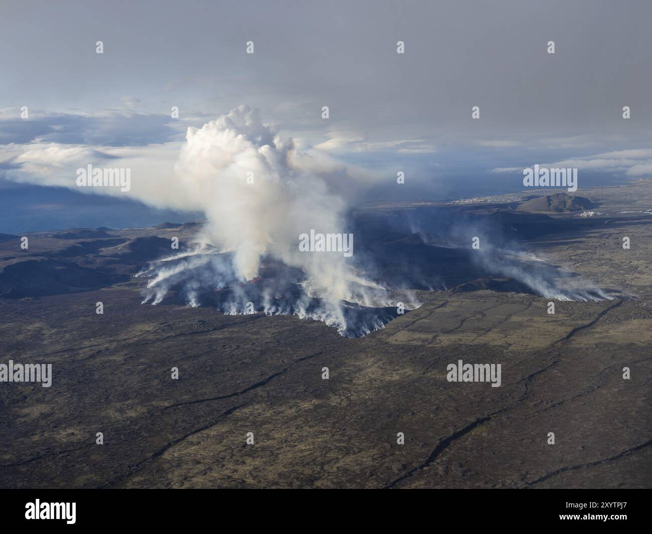 Volcanic eruption, smoke plumes and lava field, aerial view, near ...