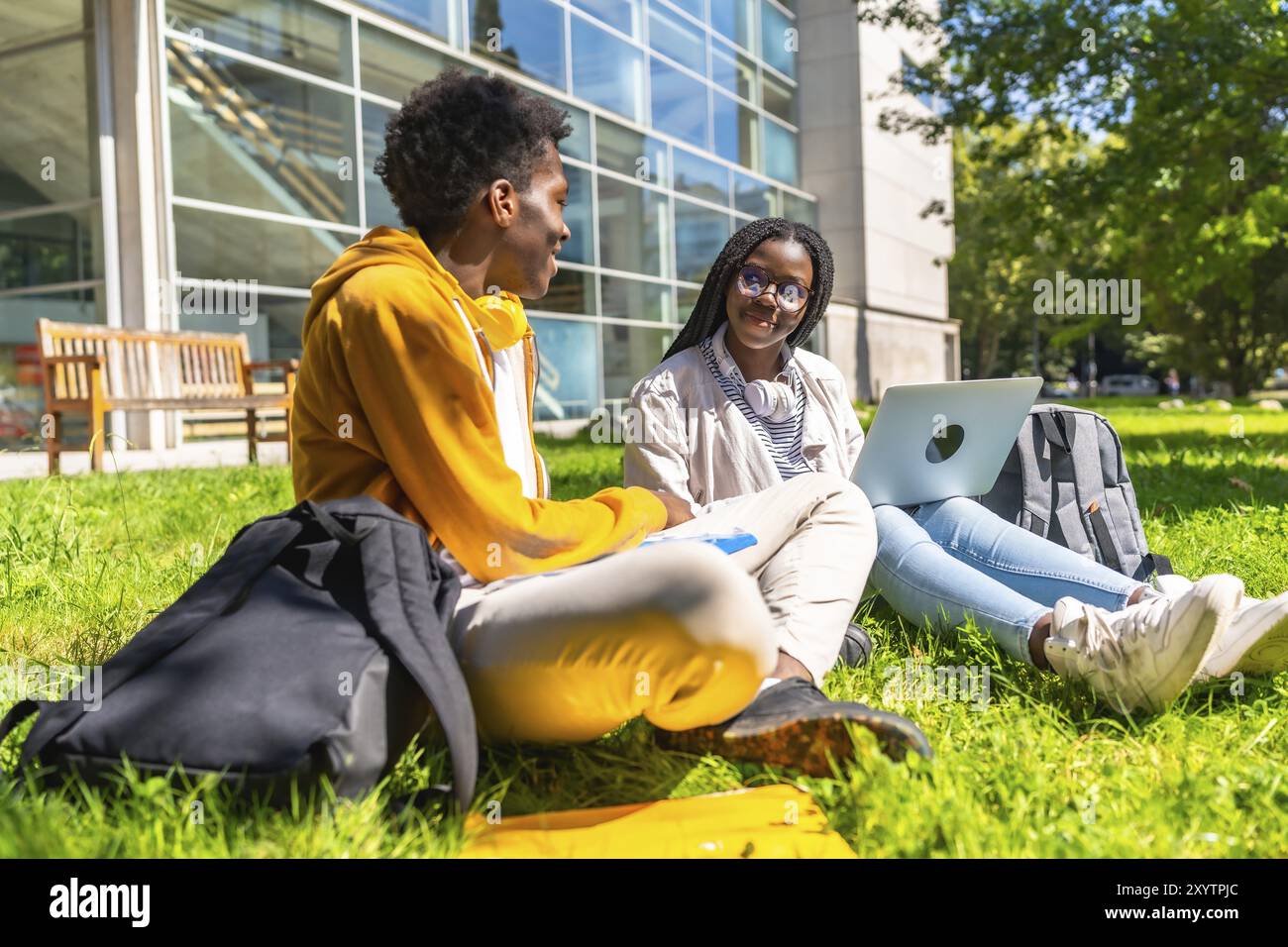 African university colleagues studying together using laptop sitting on ...